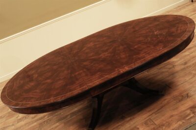 Custom 72-inch mahogany pedestal table with self-storing leaf.