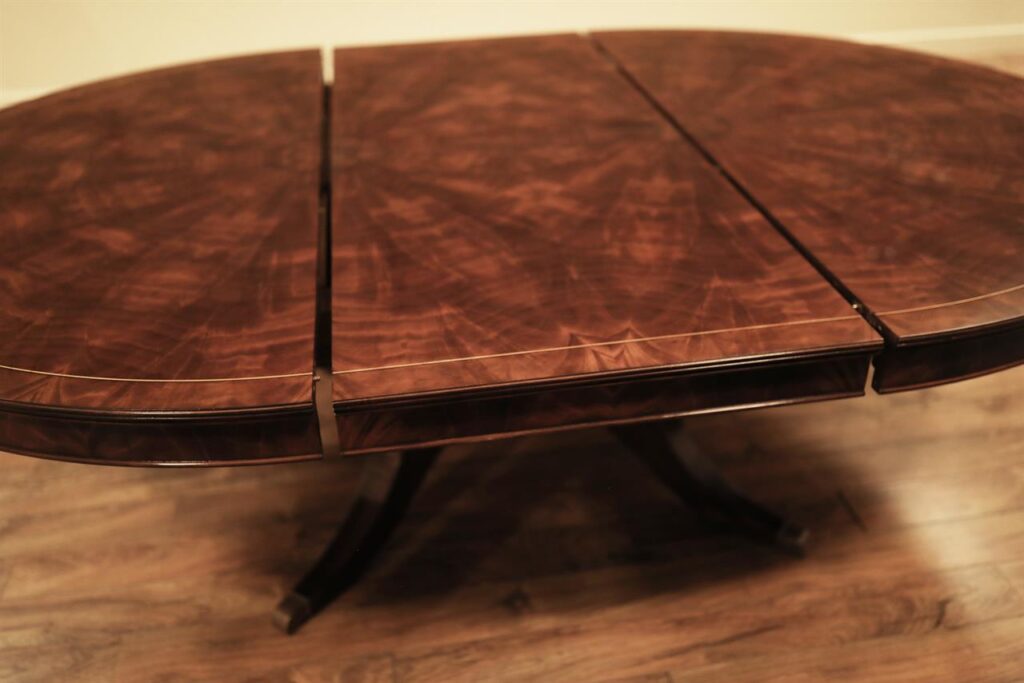 Custom 72-inch mahogany pedestal table with self-storing leaf.